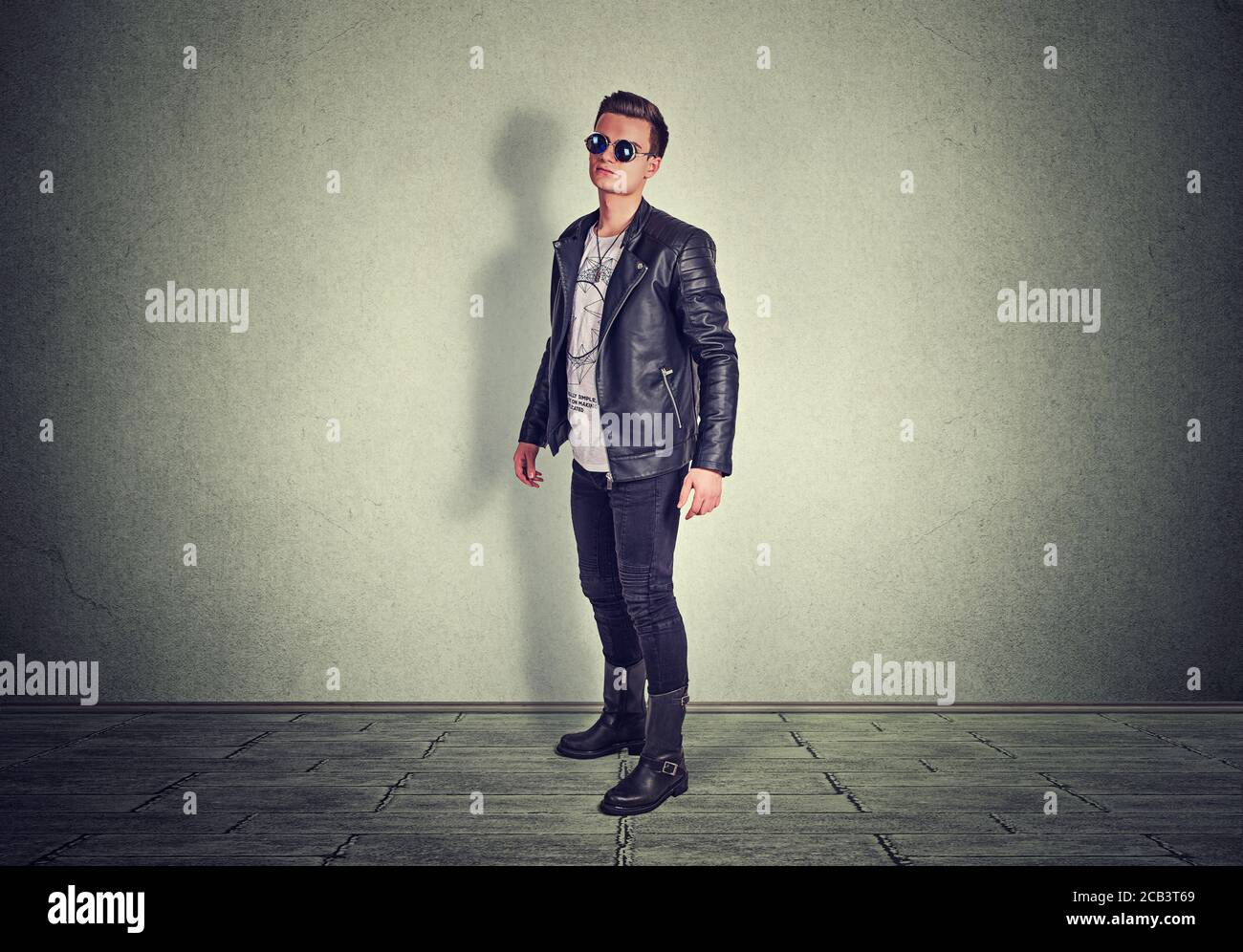 Portrait of confident young man looking at you camera standing in ...