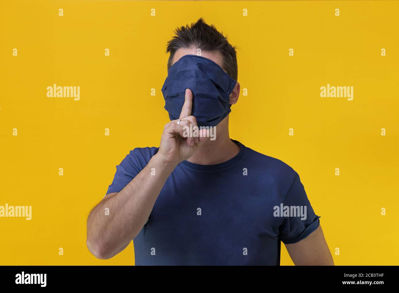 Closeup portrait of a male wearing a medical mask over his whole face ...
