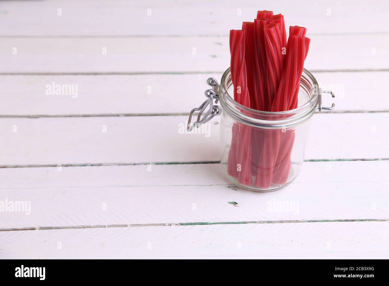 Closeup of red candy sticks in a jar on a white background Stock Photo ...