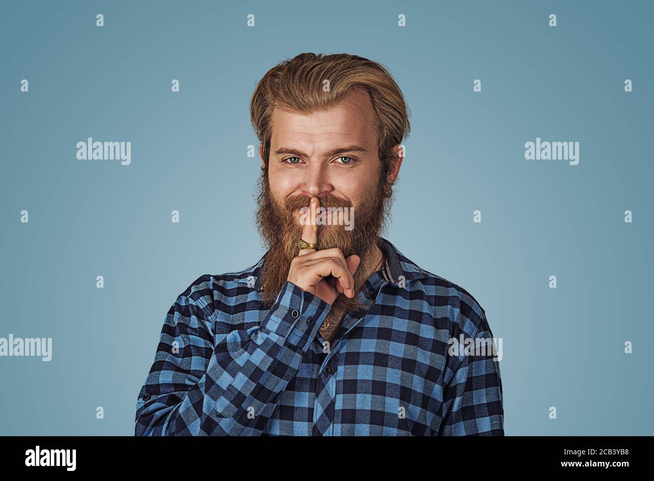 Smiling smug man hipster guy keeps a secret. Confidential information ...