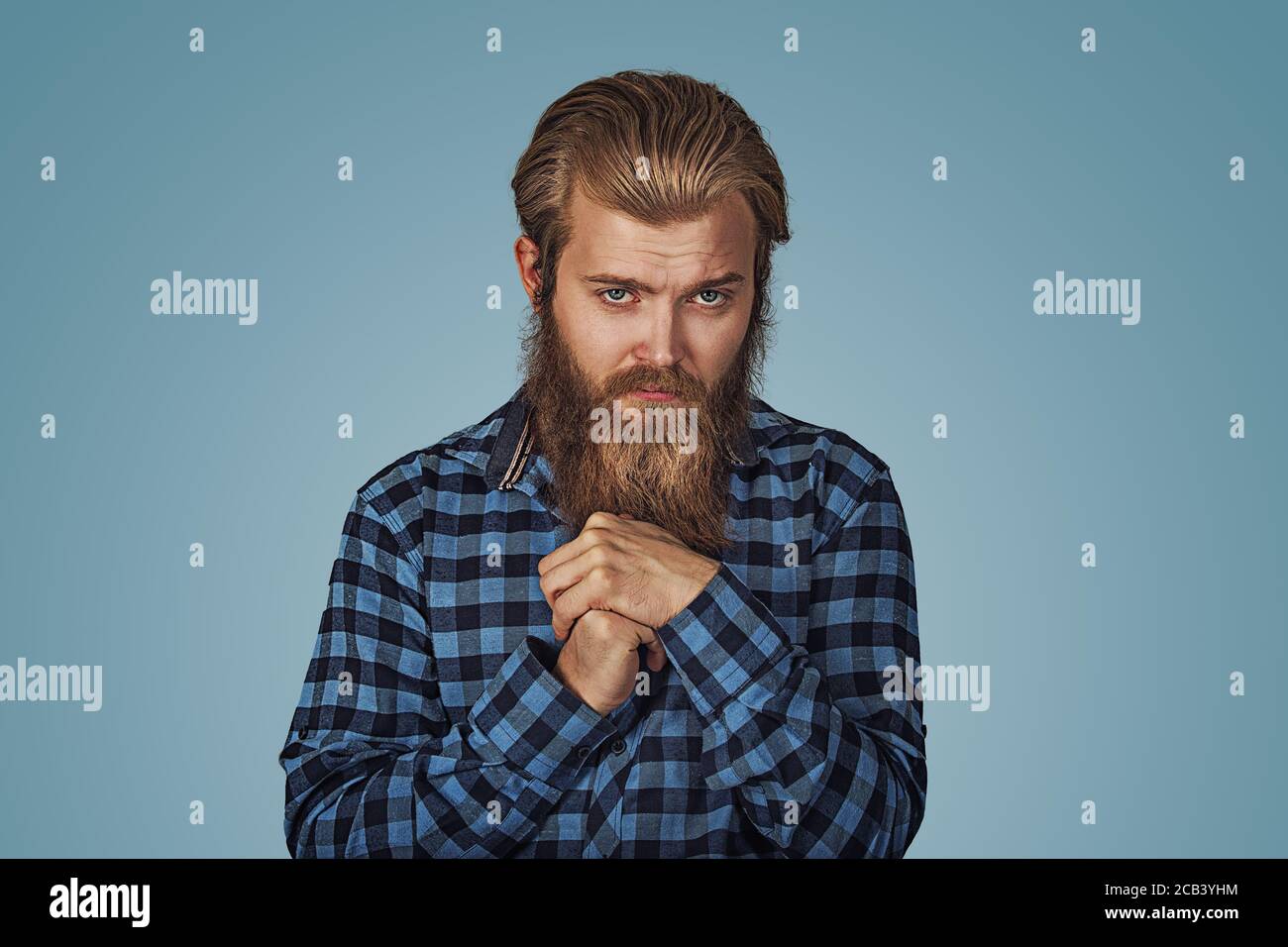 Portrait young man in unpleasant awkward situation playing nervously ...