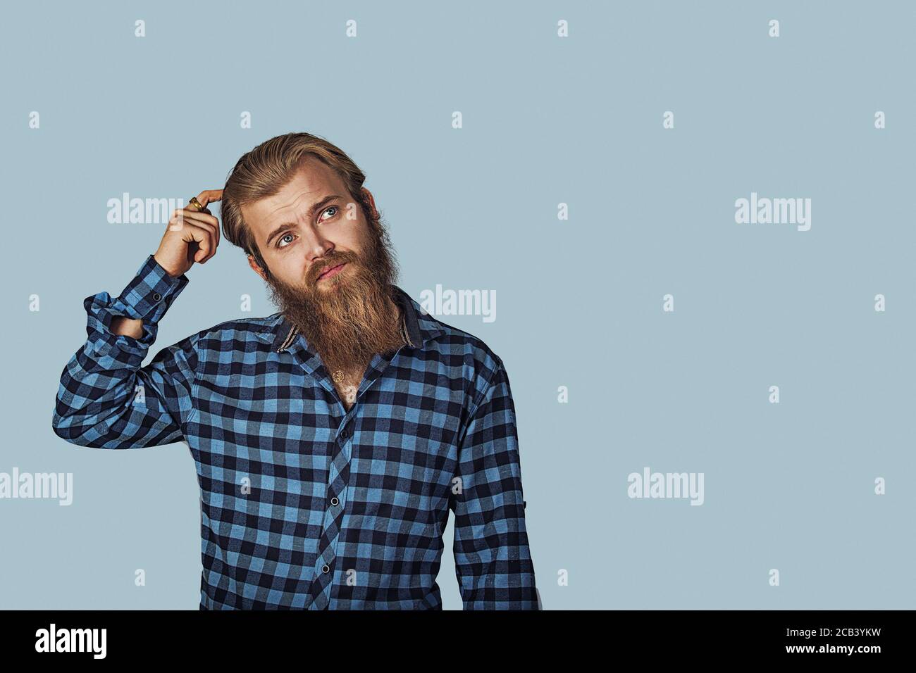 Thinking perplexed man looking up. Thoughtful guy scratching head ...