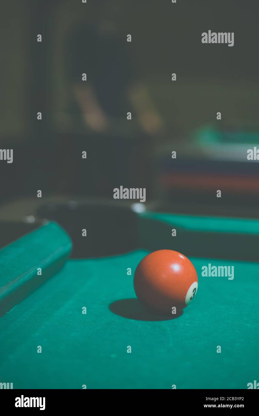 Red, number 3, billiard ball in a pool table. Vintage style noise ...