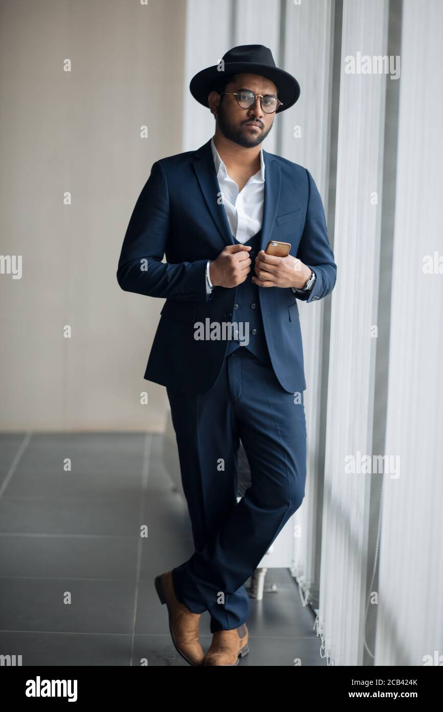 gorgeous actor with smartphone looking at the camera. full length photo ...