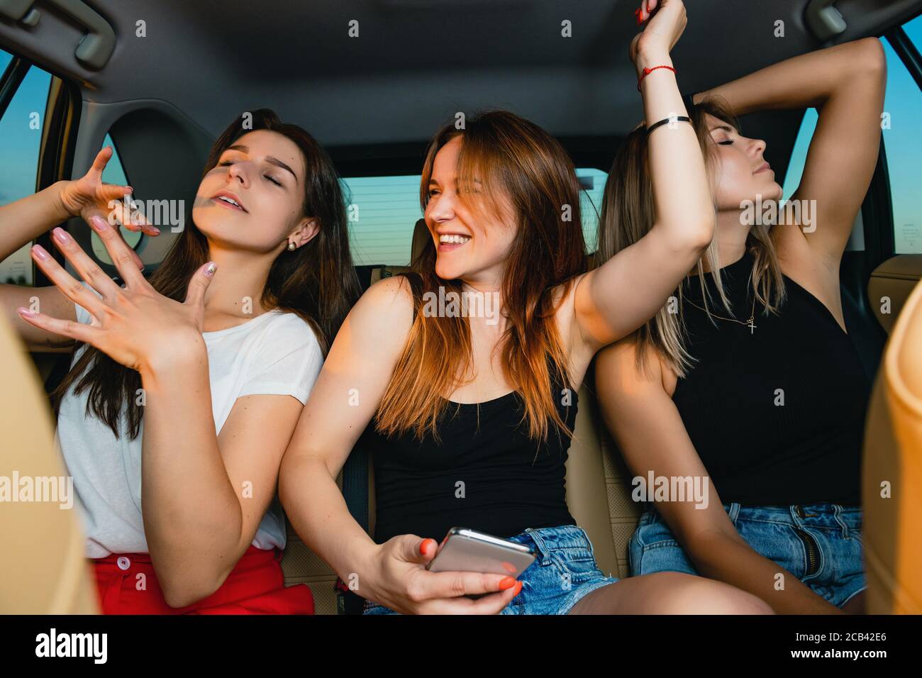 Three women friends rear hi-res stock photography and images - Alamy