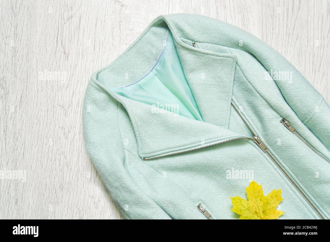 Mint jacket and maple leaf. Fashionable concept Stock Photo - Alamy