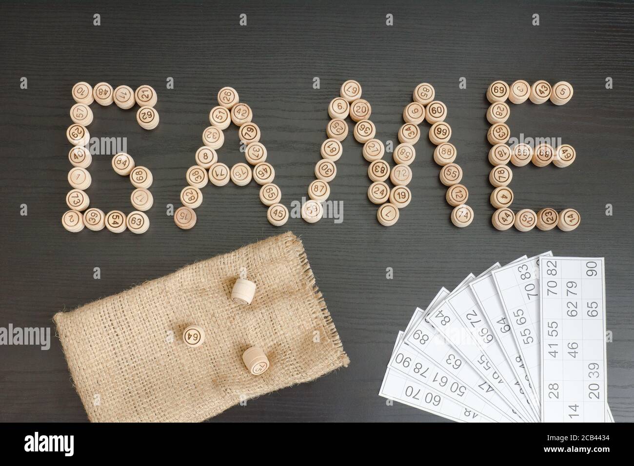 Word Game from wooden barrels and cards. Black wooden table Stock Photo ...