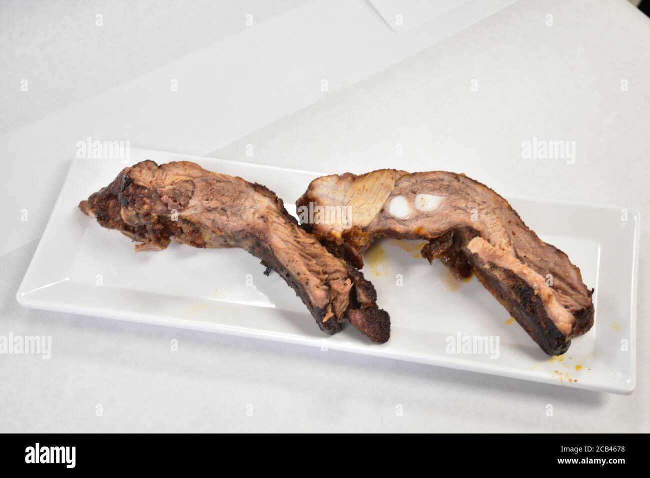Two Well-Done Ribs Plated on a White Background Stock Photo - Alamy