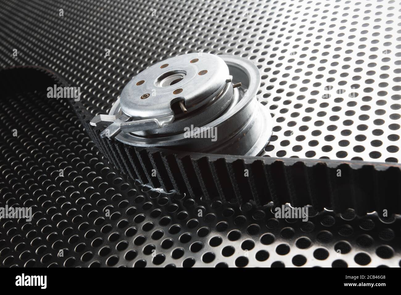 Bearing tensioner and timing belt on a metal surface Stock Photo - Alamy