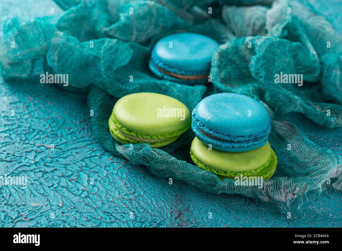 Cookies macaroon blue and green color on a turquoise background Stock ...