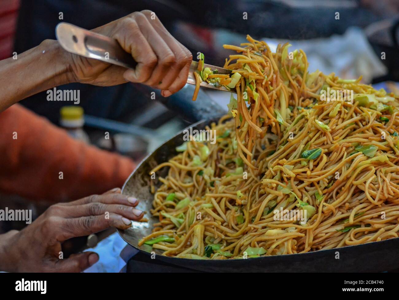 Stiring the Chow Mein at a street food stall in Assam, India Stock ...
