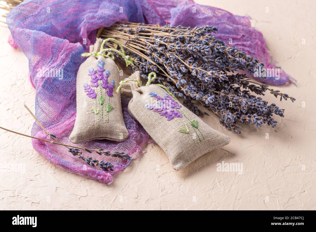 Two aromatic embroidered sachets filled with dried lavender and a ...
