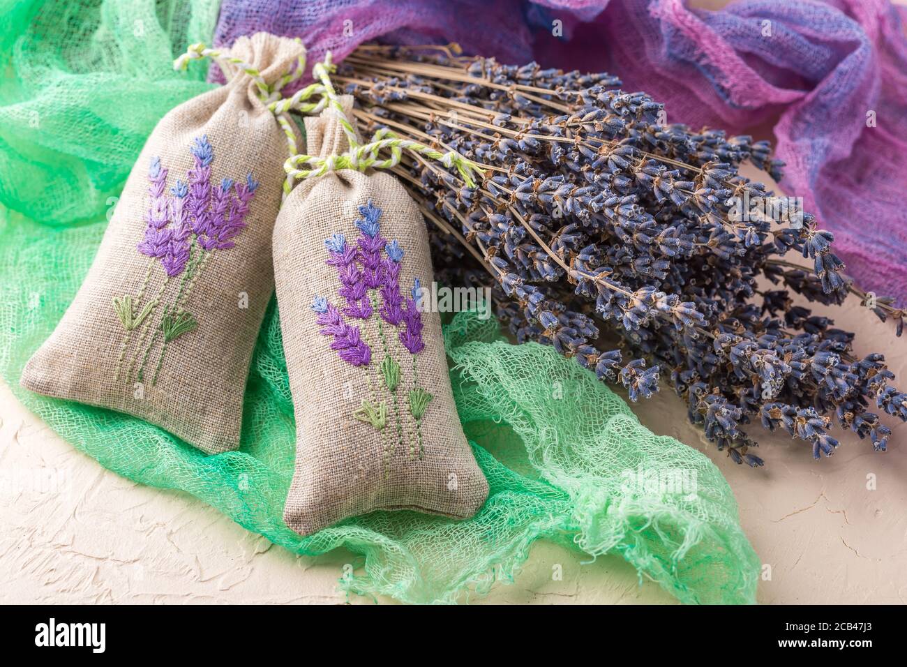 Two aromatic embroidered sachets filled with dried lavender and a ...