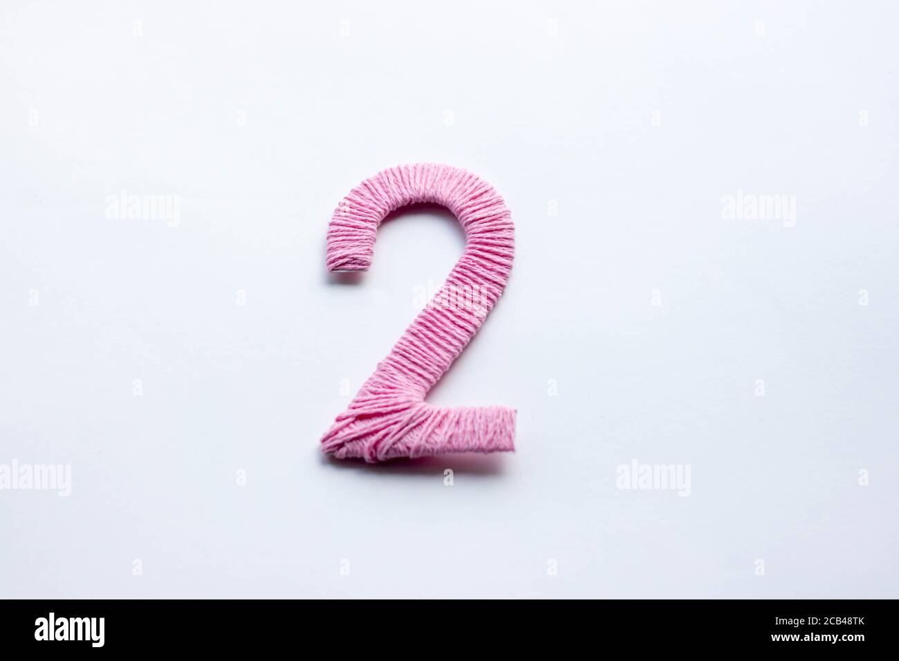 number two, decorative numeral on pink surface Stock Photo - Alamy