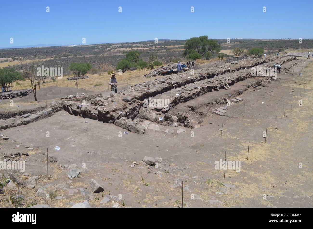 Archeologists work on the ruins of an ancient ball court at the ...