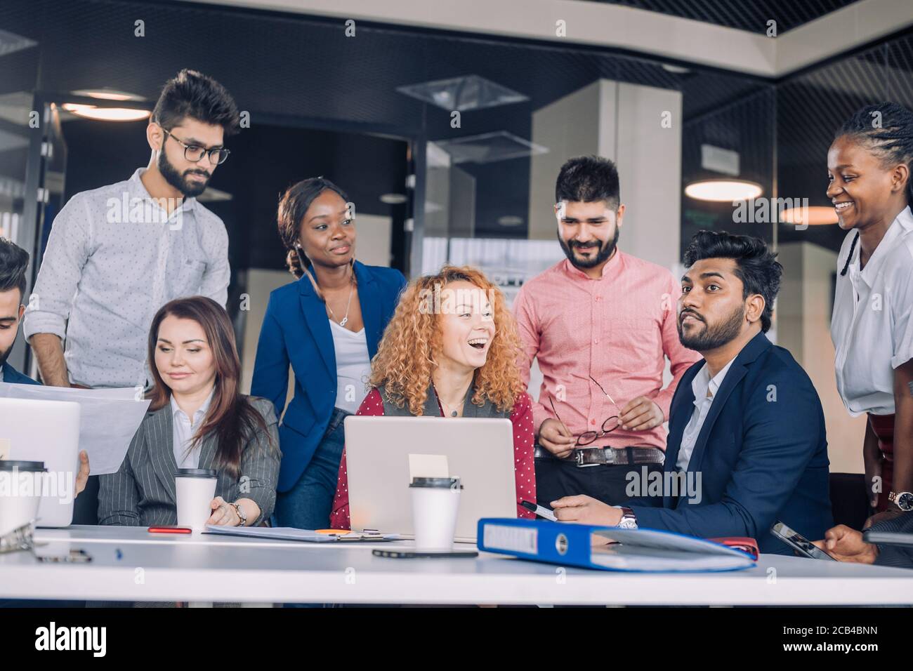 Group around computer screen standing hi-res stock photography and ...