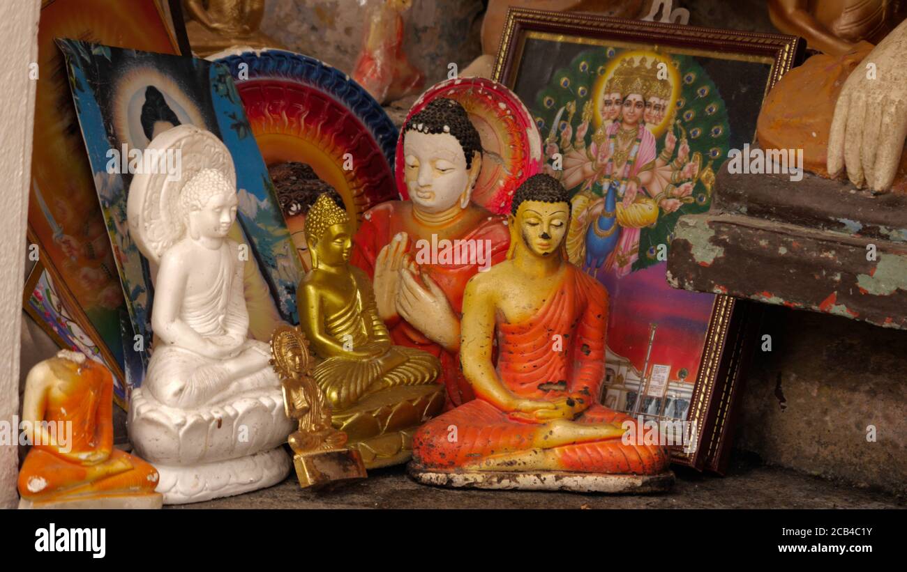 Closeup shot of old religious statues and pictures in a temple, Sri ...