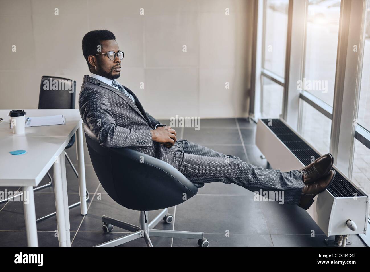 serious business man is resting in the chair after the meeting. side ...