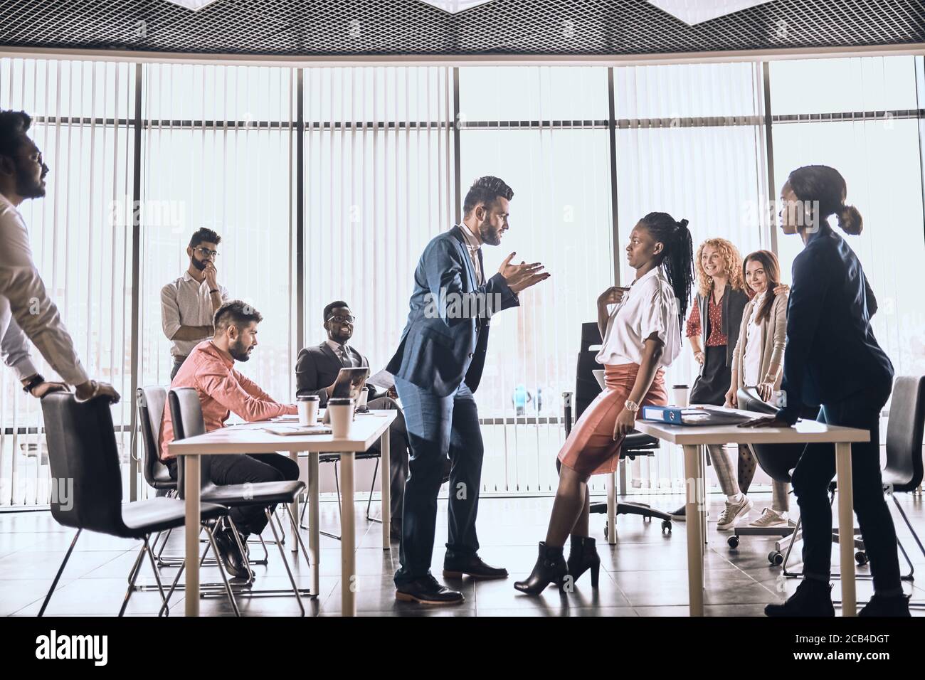 boss is scolding female employee in fron of colleagues. conflictual ...