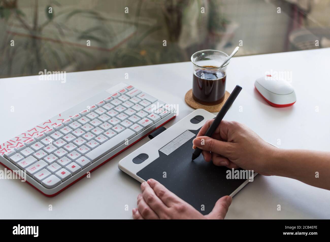 Female hand drawing on a graphic tablet Stock Photo - Alamy