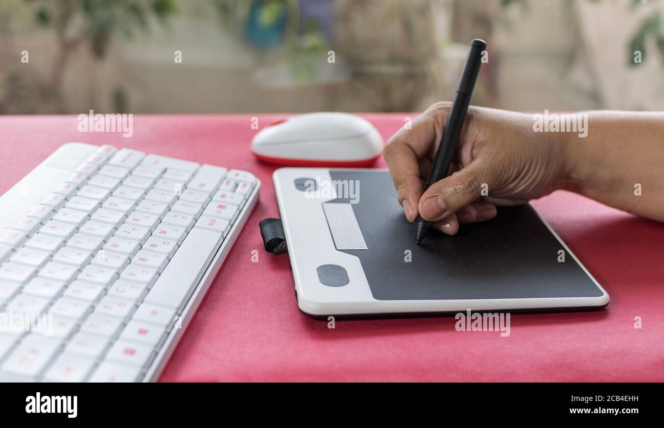 Female hand drawing on a graphic tablet Stock Photo - Alamy
