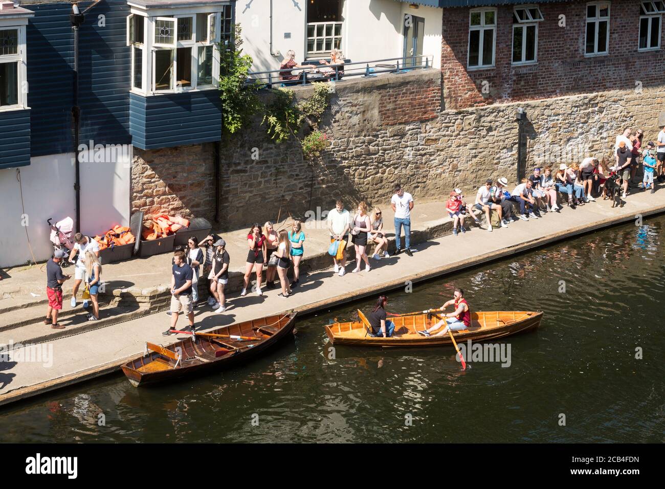 People queuing to hire Browns rowing boats on the river in Durham City ...