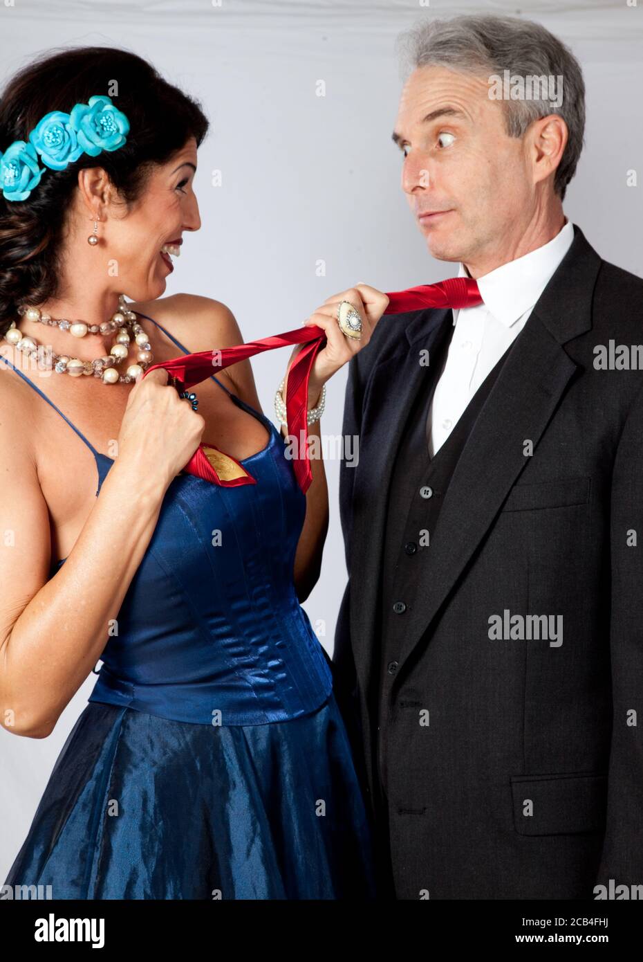 Romantic couple with her playfully pulling is tie Stock Photo - Alamy