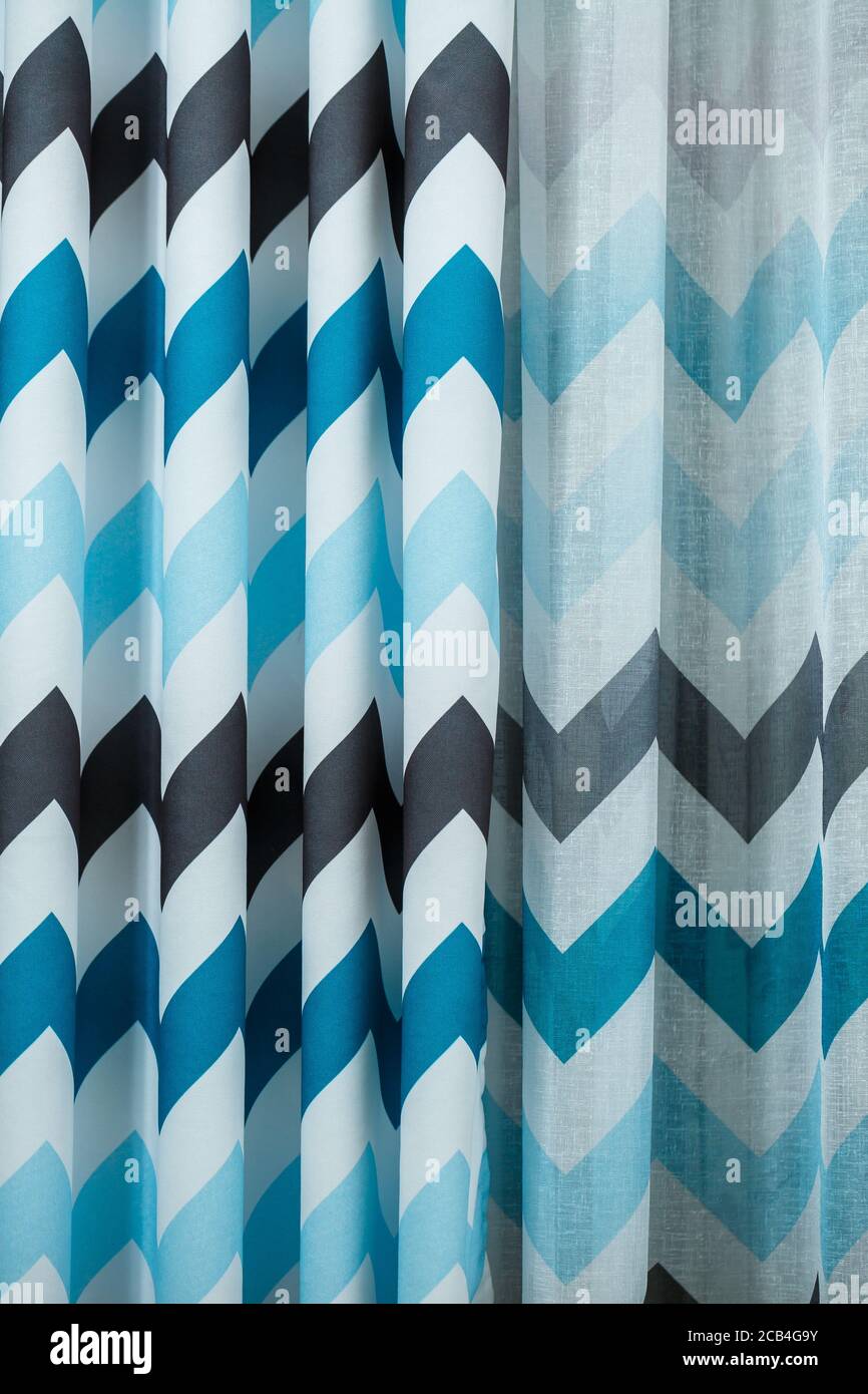 Curtain samples hanging from hangers on rail in store. Fabric texture ...
