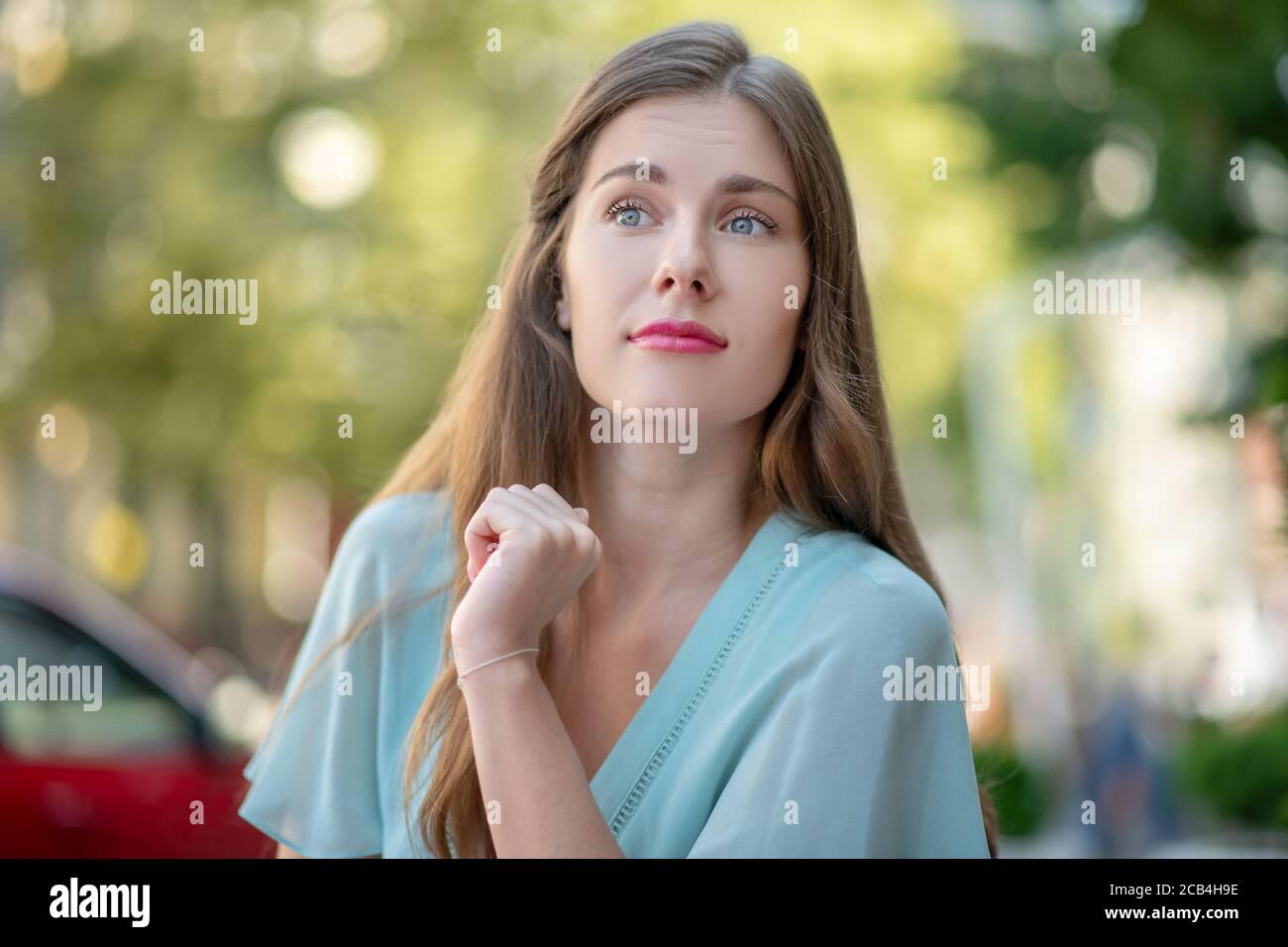 Romantic female in blue dress waiting for someone Stock Photo - Alamy