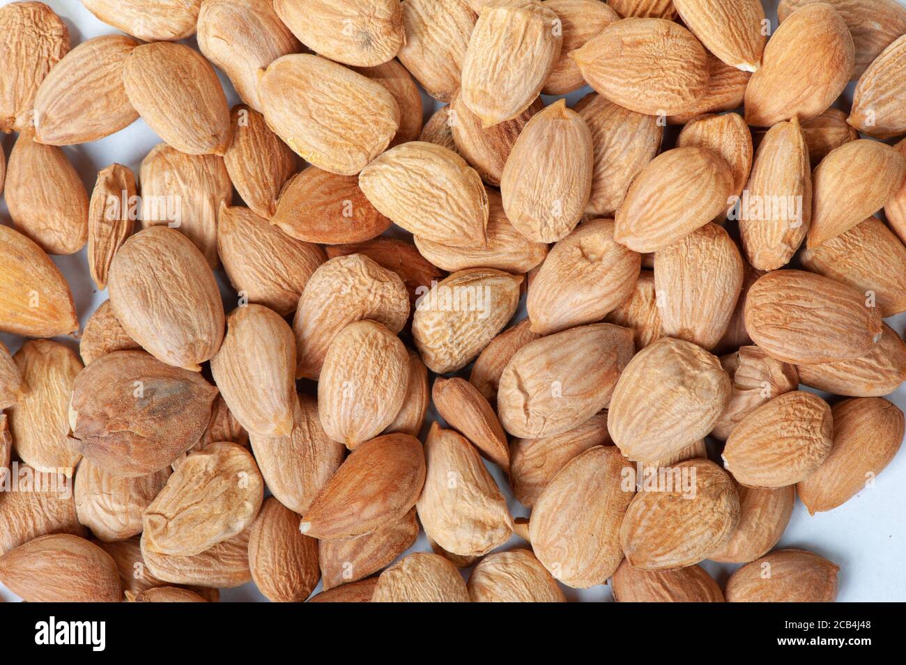 Background full of peeled apricot kernels Stock Photo - Alamy