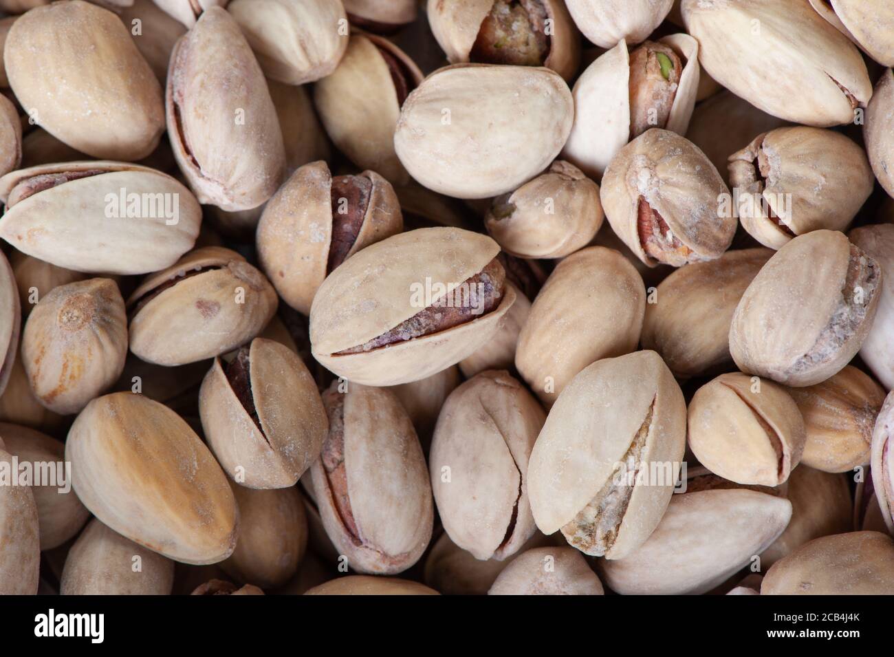 Pistachios with shell full background, closeup Stock Photo - Alamy