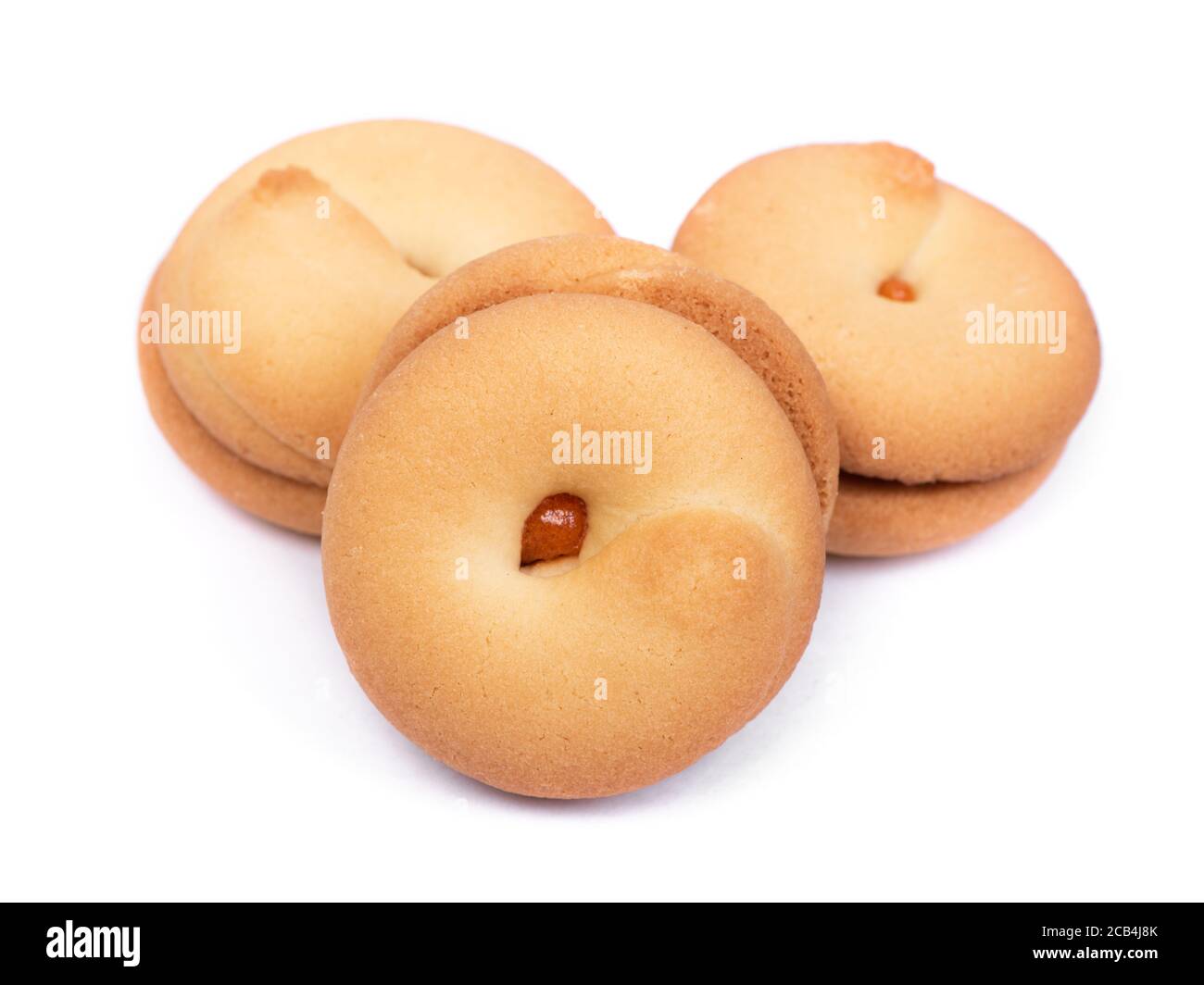 Group of round biscuit cookies with drop of jam in center isolated over ...