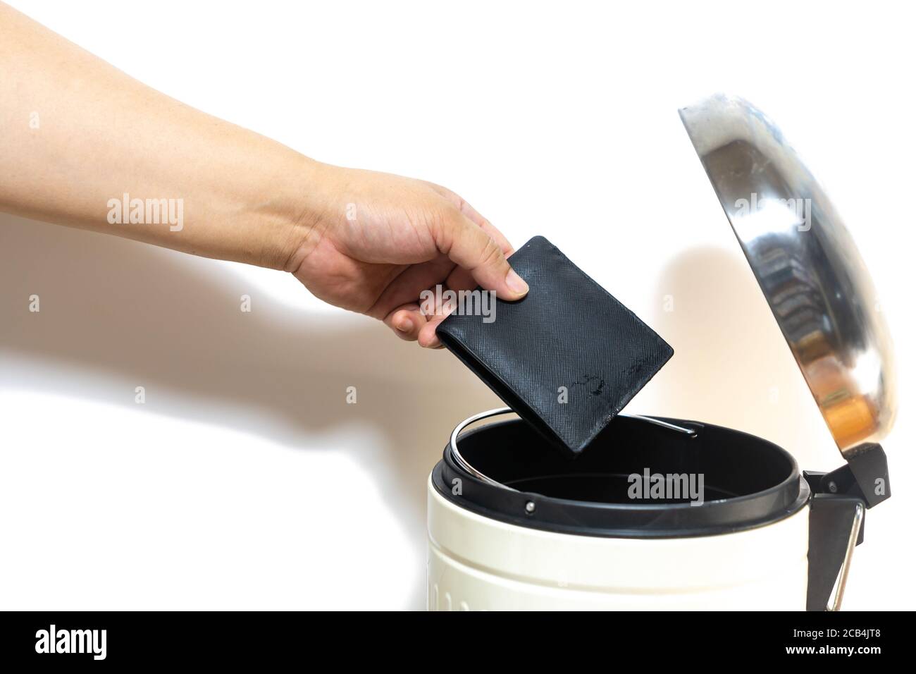 man hand throws a wallet into a trash can on white background Stock ...