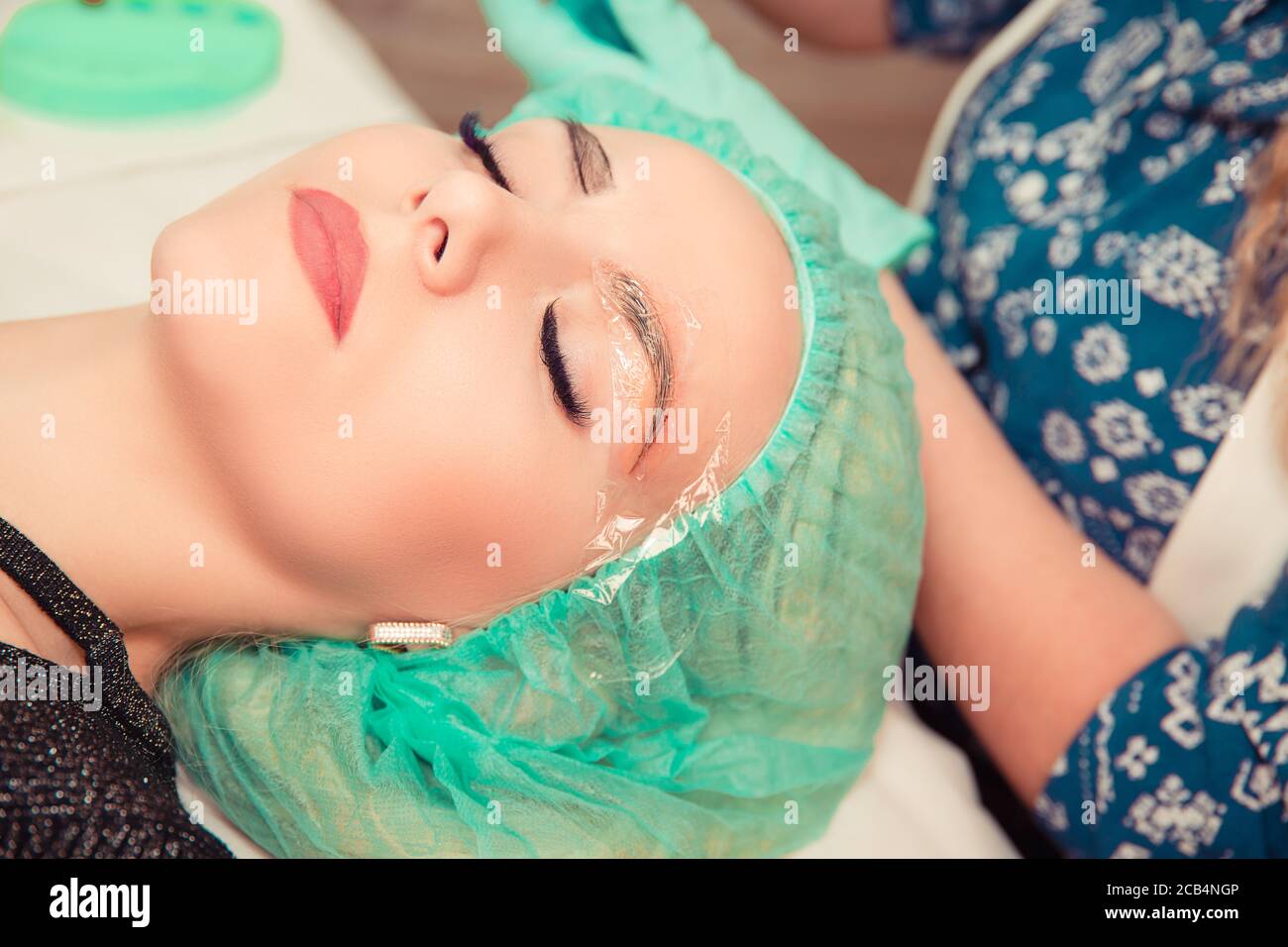 Microblading eyebrows work flow in a beauty salon. Technician is ...