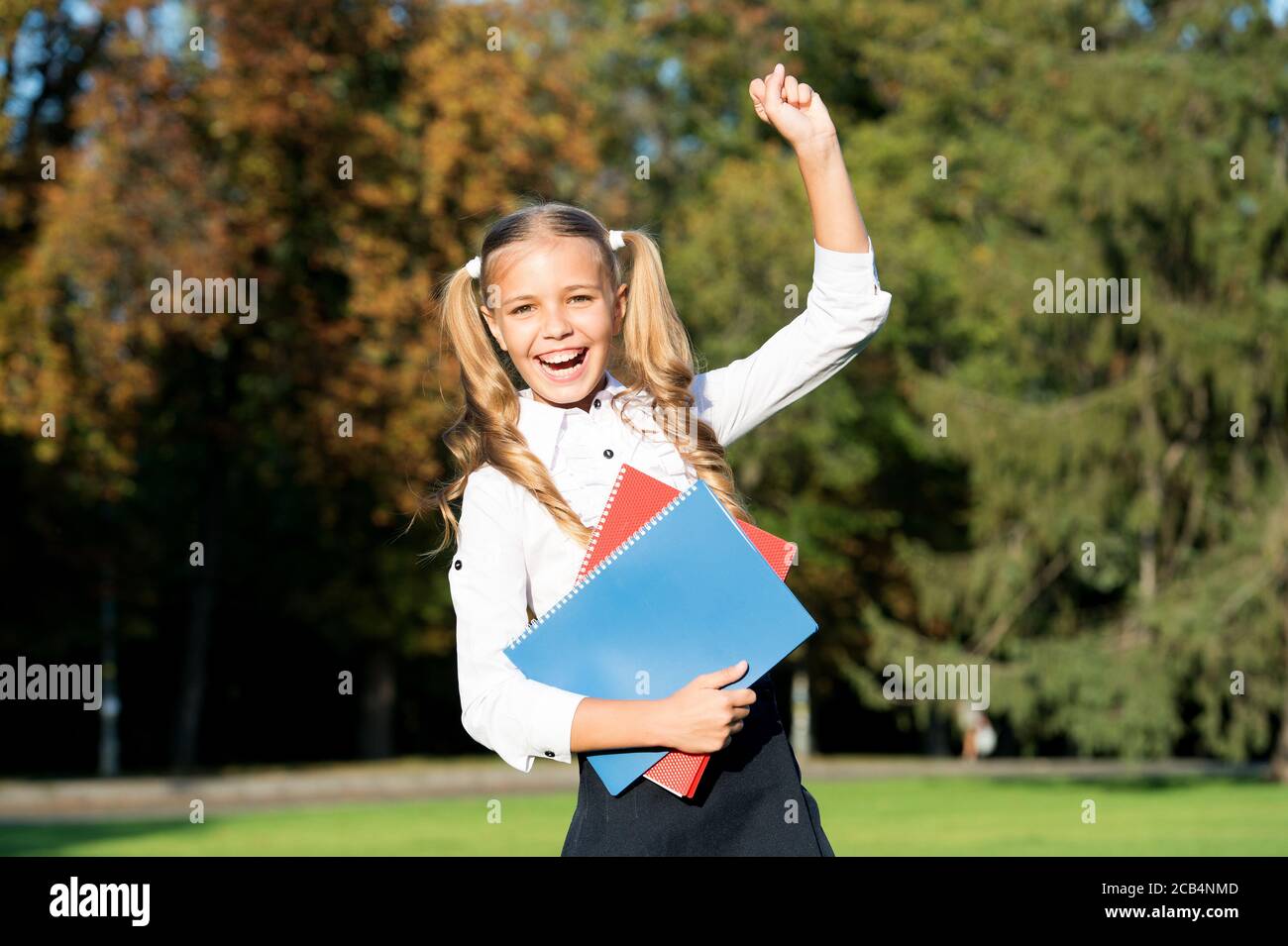 Excellent student girl study with school book outdoors, successful ...