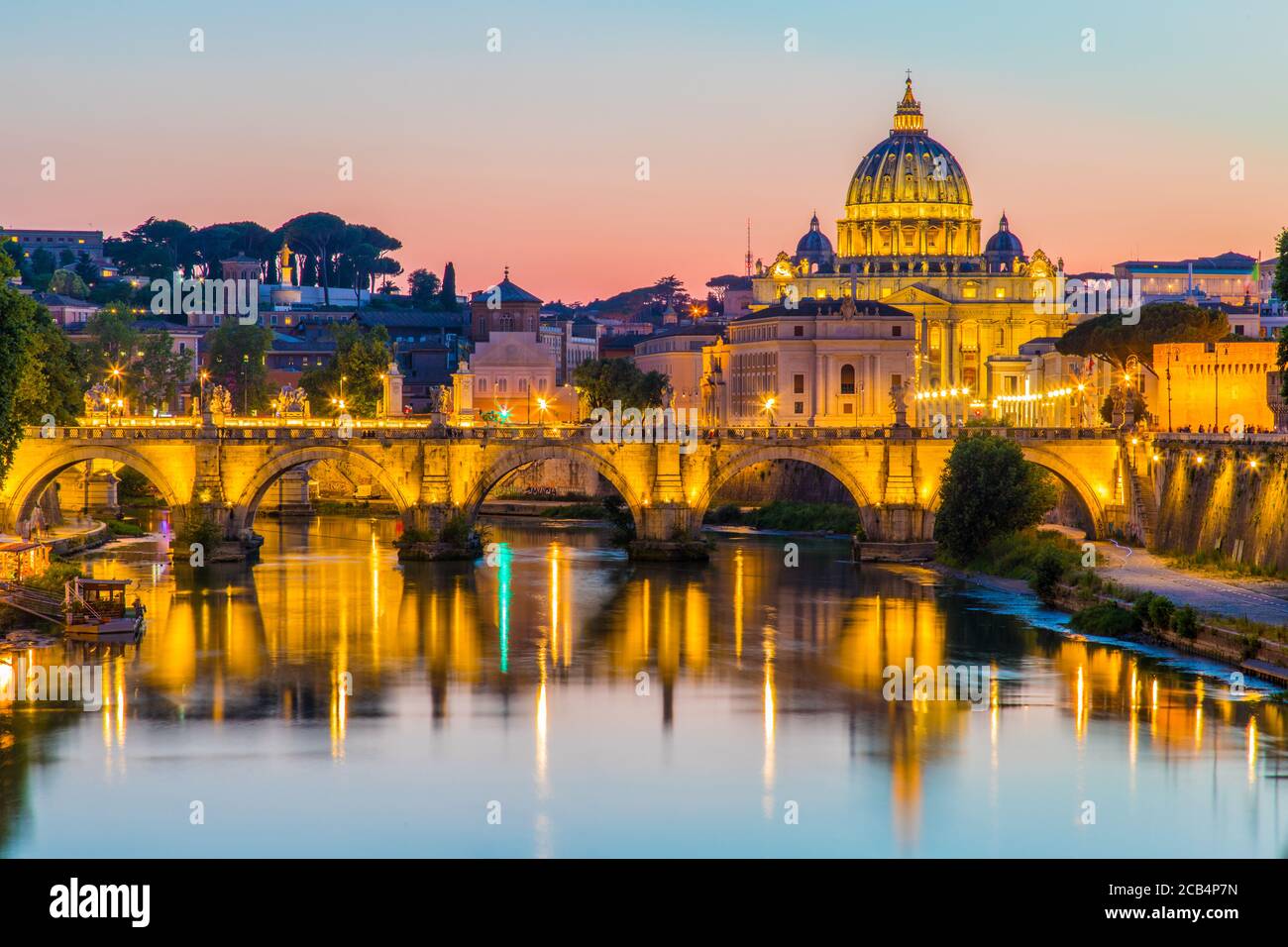 A view of Saint Peter's Basilica and Vatican City at sunset along the ...