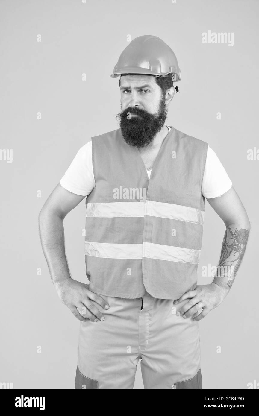 Man in construction. Working man yellow background. Bearded man in hard ...