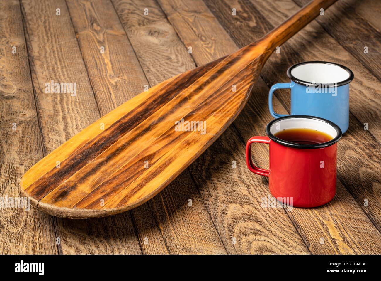 vintage wooden canoe paddle on weathered wood picnic table with metal ...