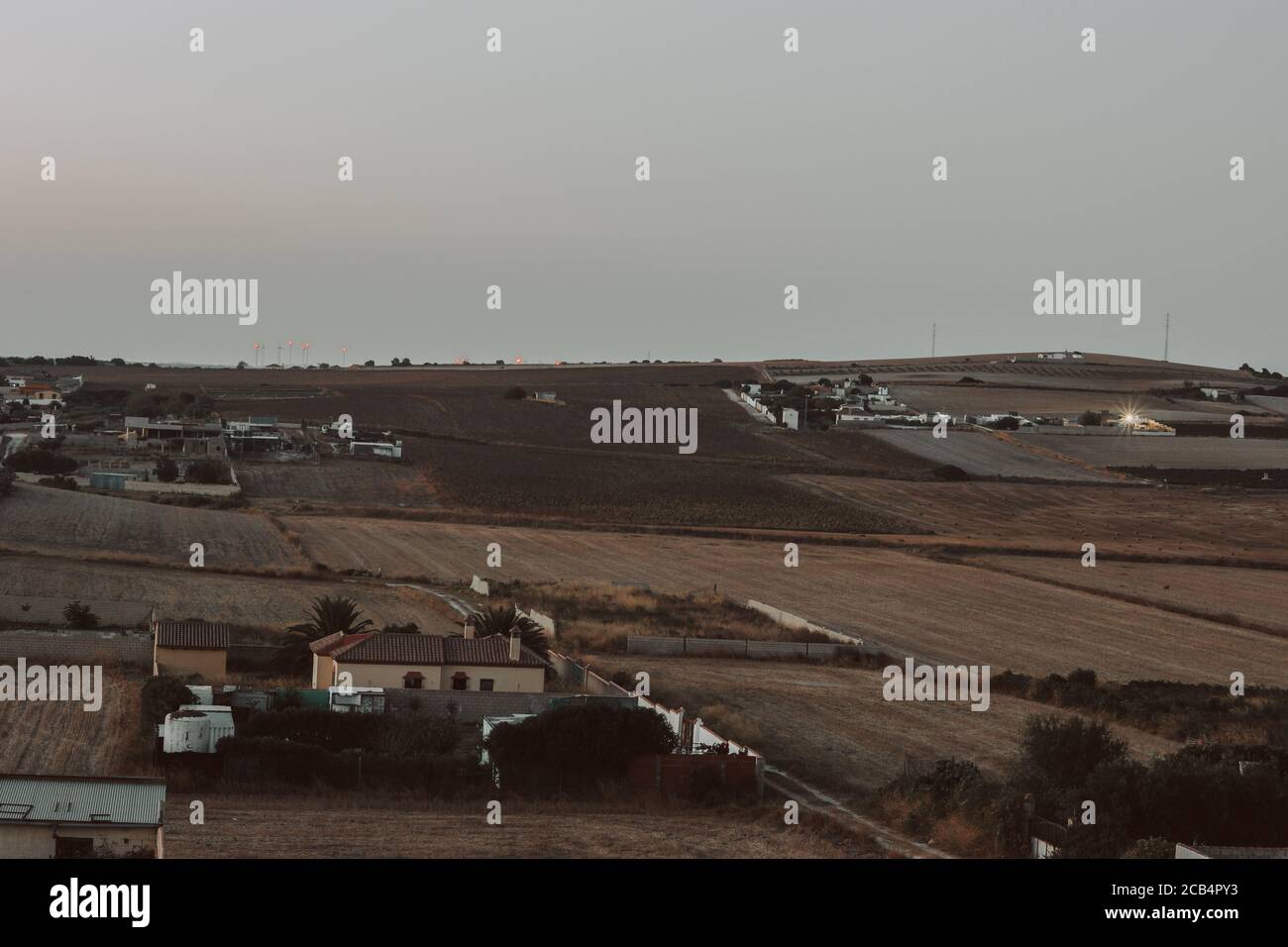 Shot of fields and residential buildings in a rural area Stock Photo ...