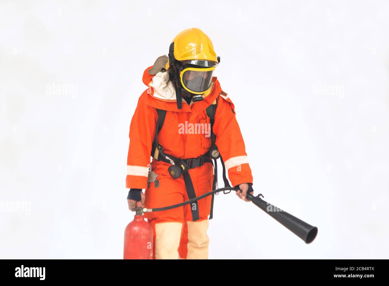A portrait of Asian male firefighter in orange protective uniform, mask ...