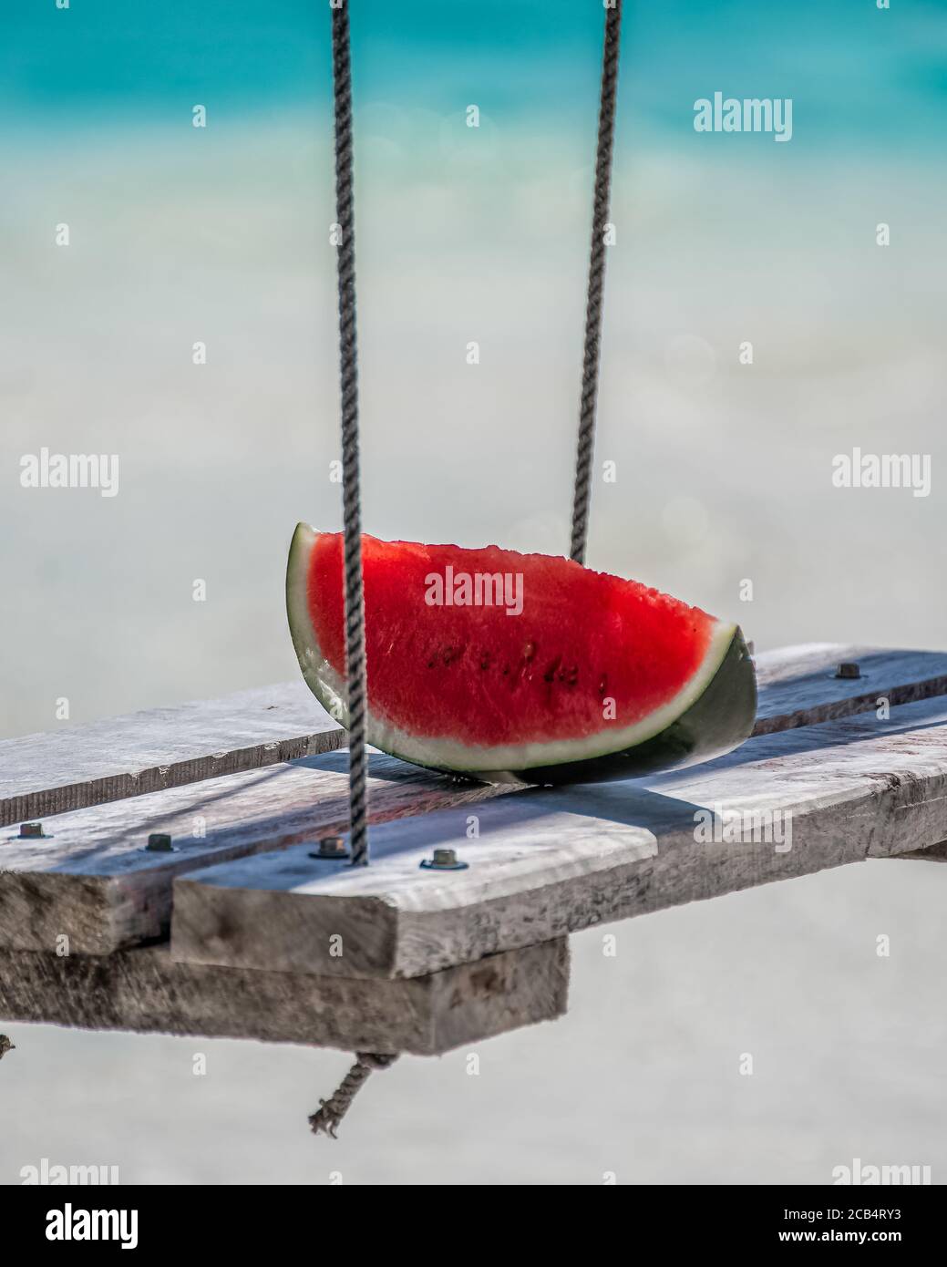 Shallow focus shot of a slice of a watermelon on a swing Stock Photo ...