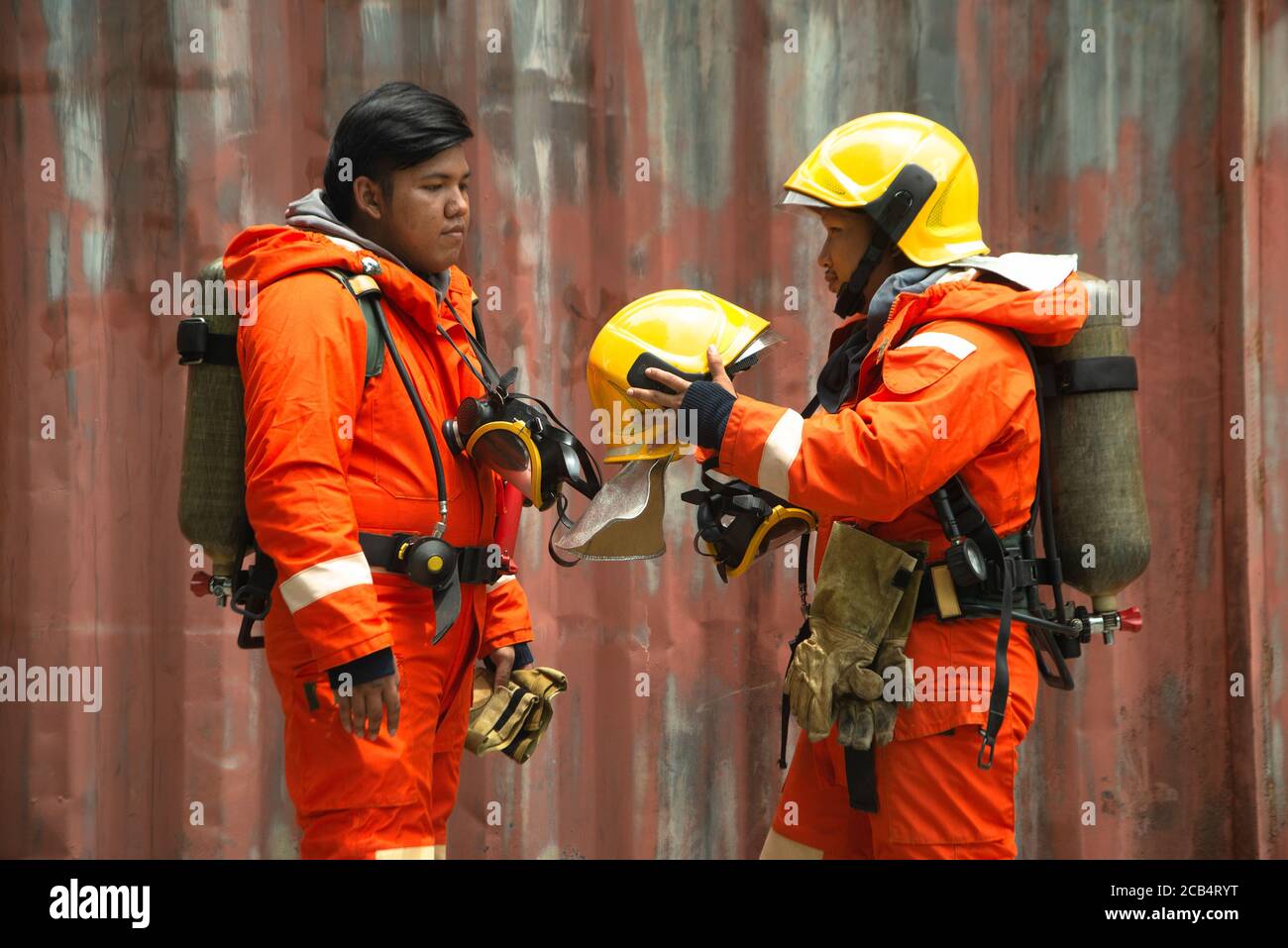 The portrait of Asian firefighters are wearing orange fire protection ...