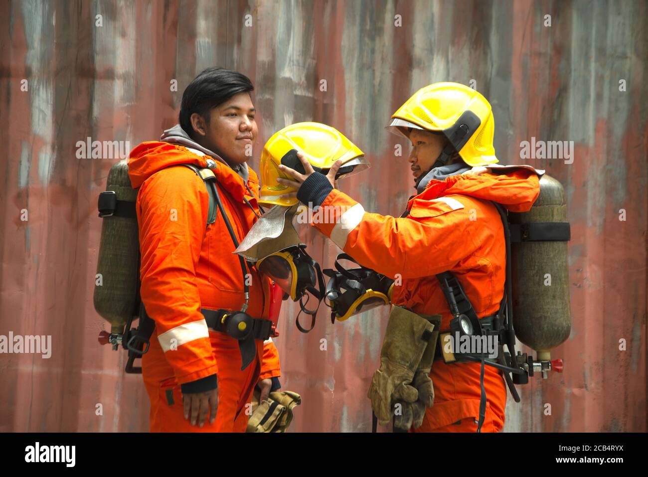 The portrait of Asian firefighters are wearing orange fire protection ...