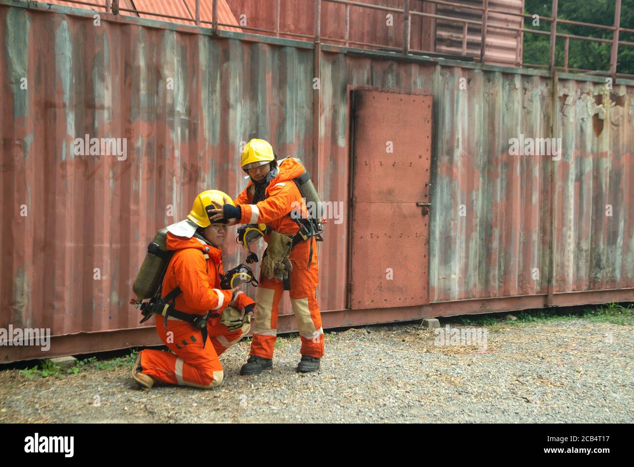 The portrait of Asian firefighters are wearing orange fire protection ...