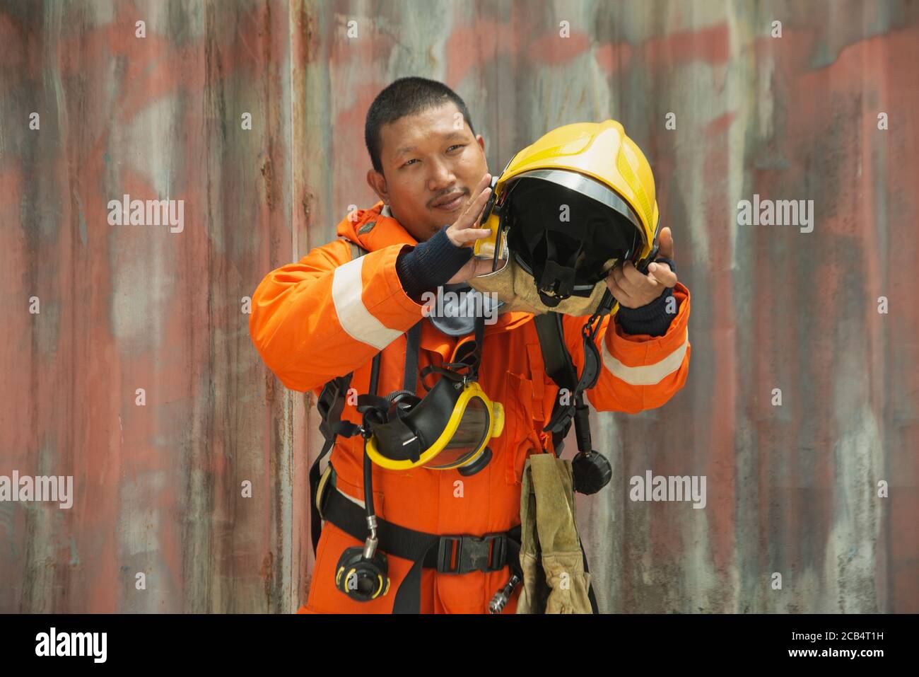 The portrait of Asian firefighters are wearing orange fire protection ...