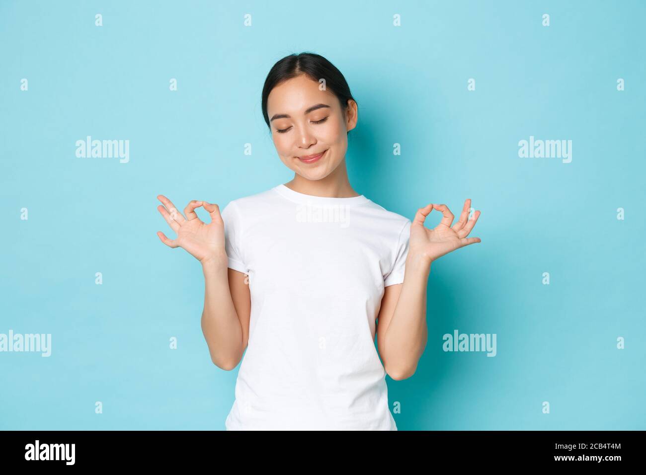 Patience is key. Calm and relaxed smiling asian girl with closed eyes ...