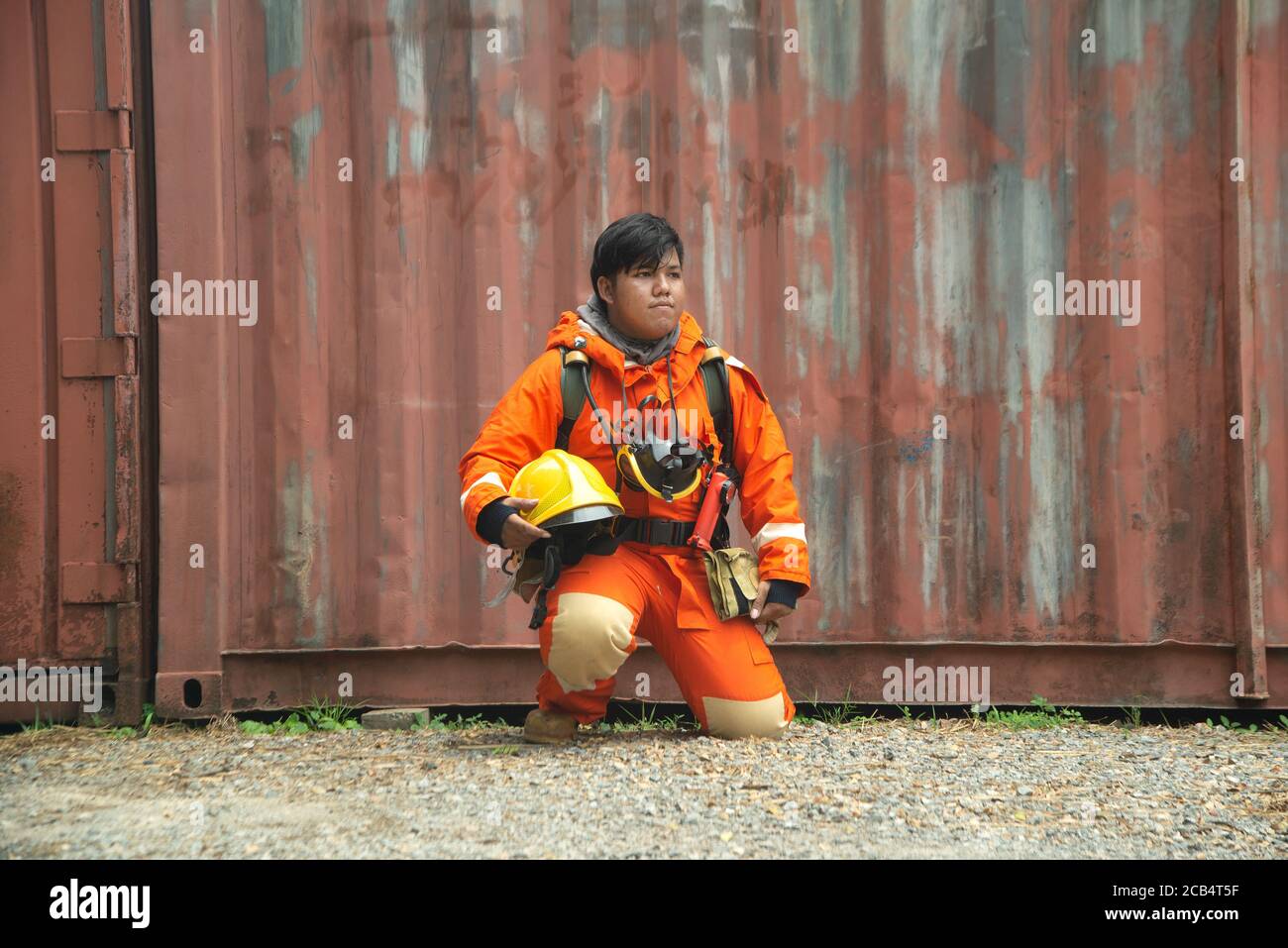 The portrait of young Asian firefighters are wearing orange fire ...