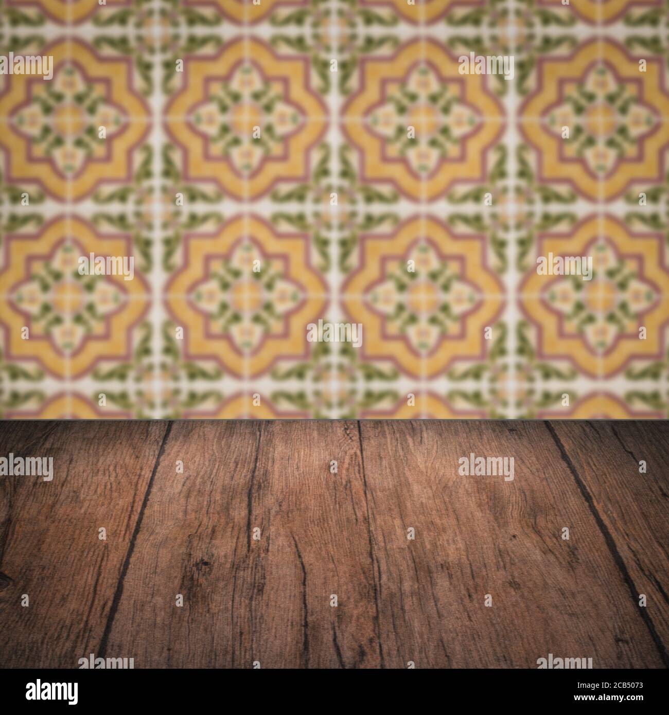 Empty wood table top and blur vintage ceramic tile pattern wall in ...