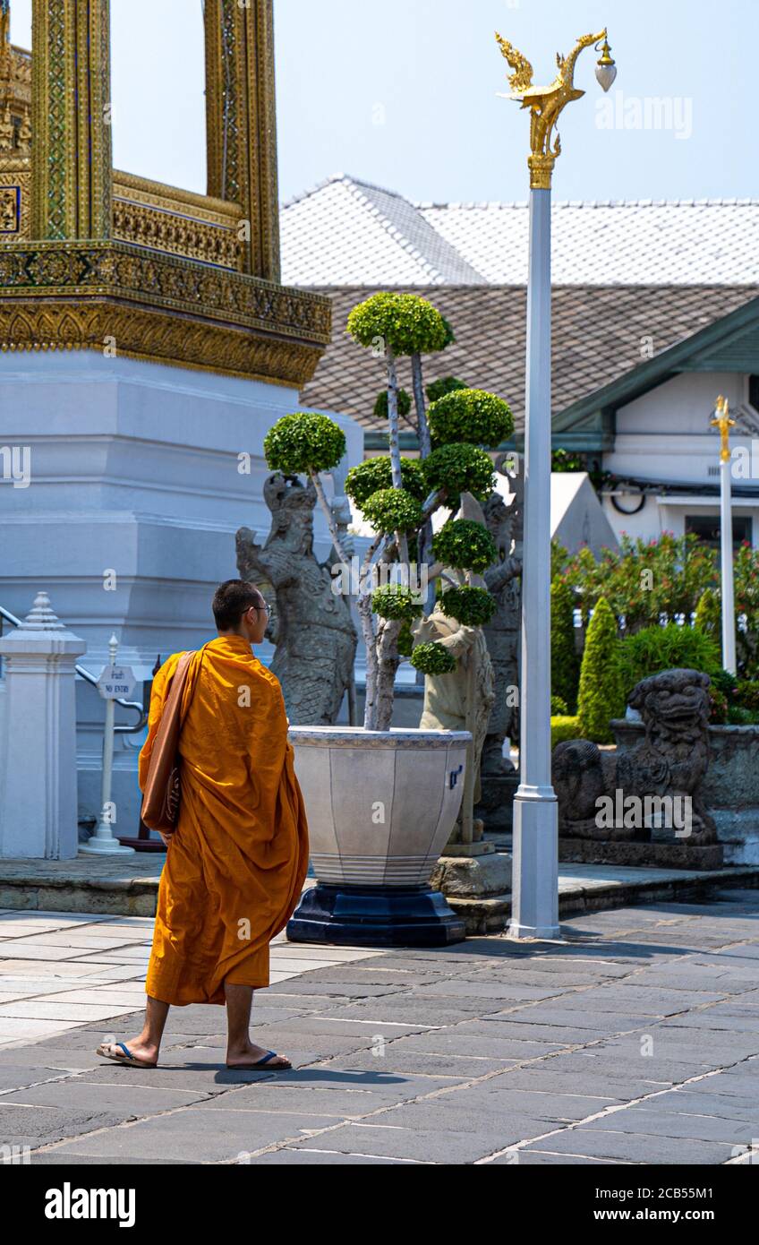 Buddhist monk standing at the emerald palace in Bangkok, Thailand Stock ...