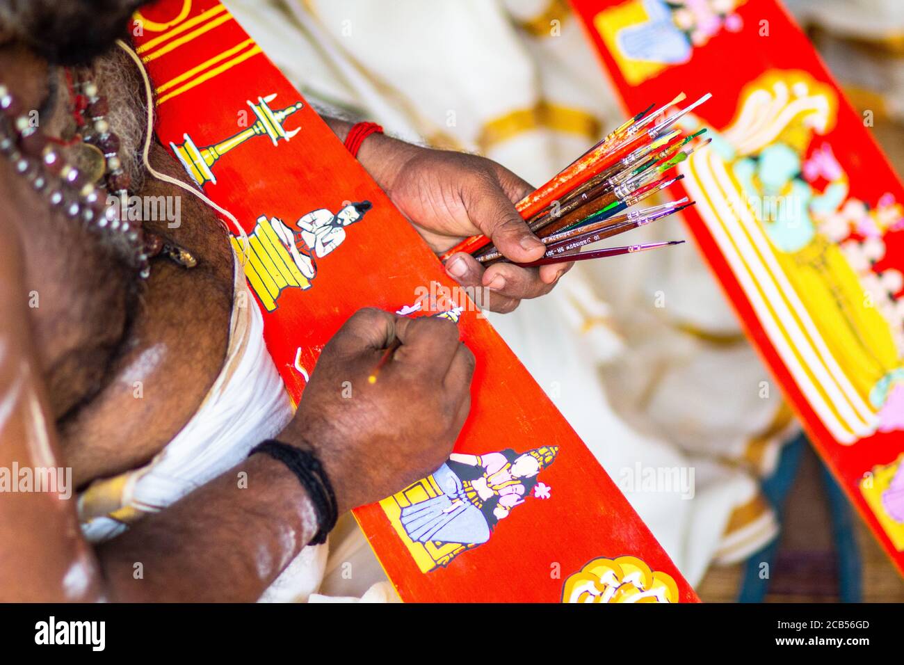 The Ceremonial bow, Onavillu. Artisan painting god's pictures on bow ...